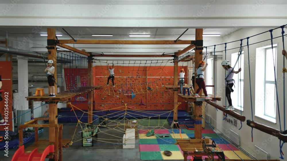 The camera flies inside the premises of the rope park, where a group of ...