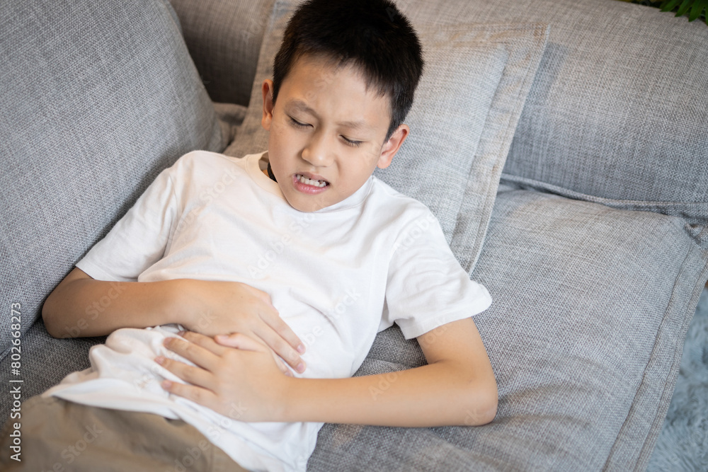 Sick asian child boy suffering from Gastritis,Gastric ulcer,stomach ...