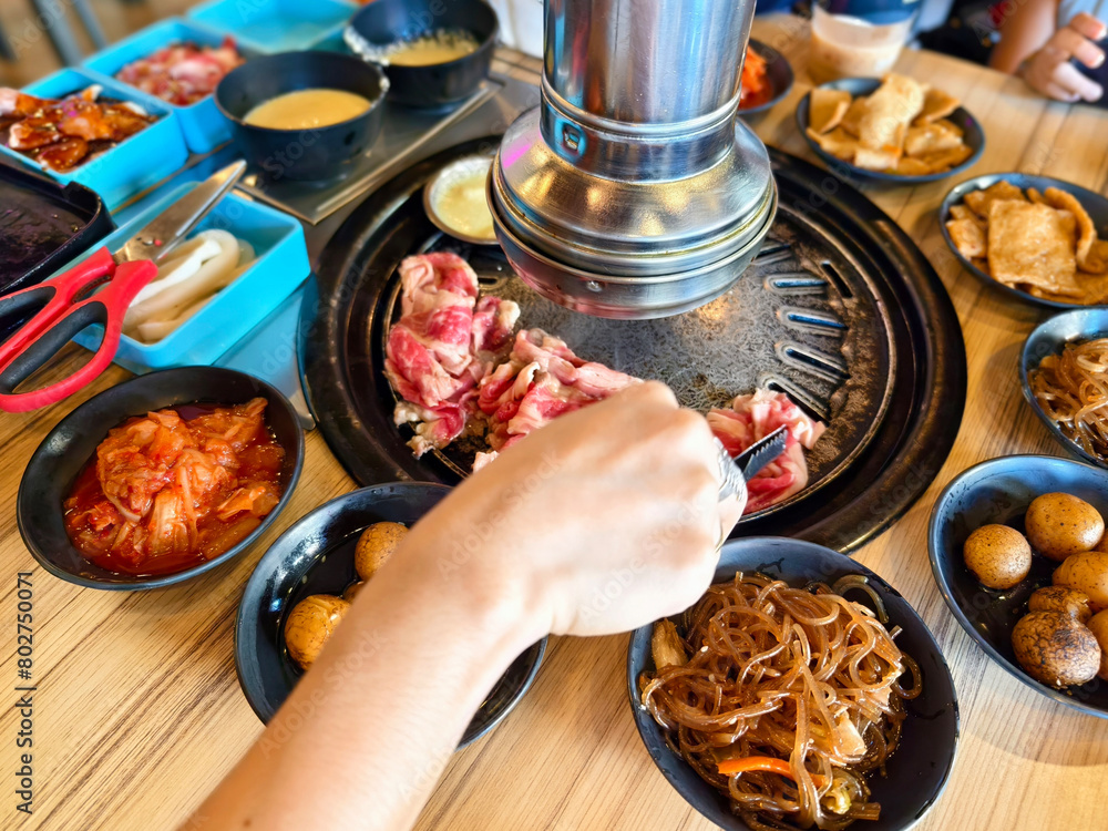 Dining experience captured at a Korean samgyupsal restaurant with fresh ...