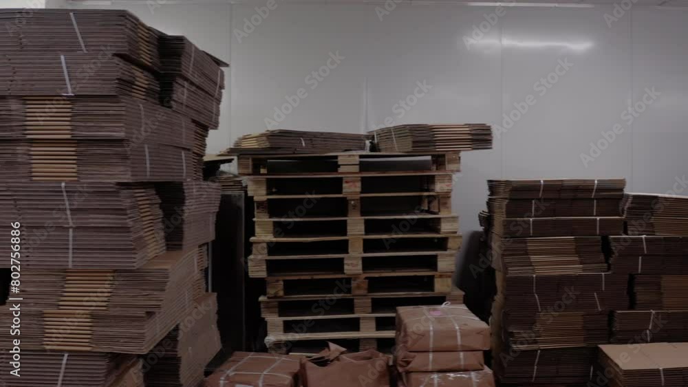 Cardboard packaging and labeled boxes neatly stacked in a warehouse ...