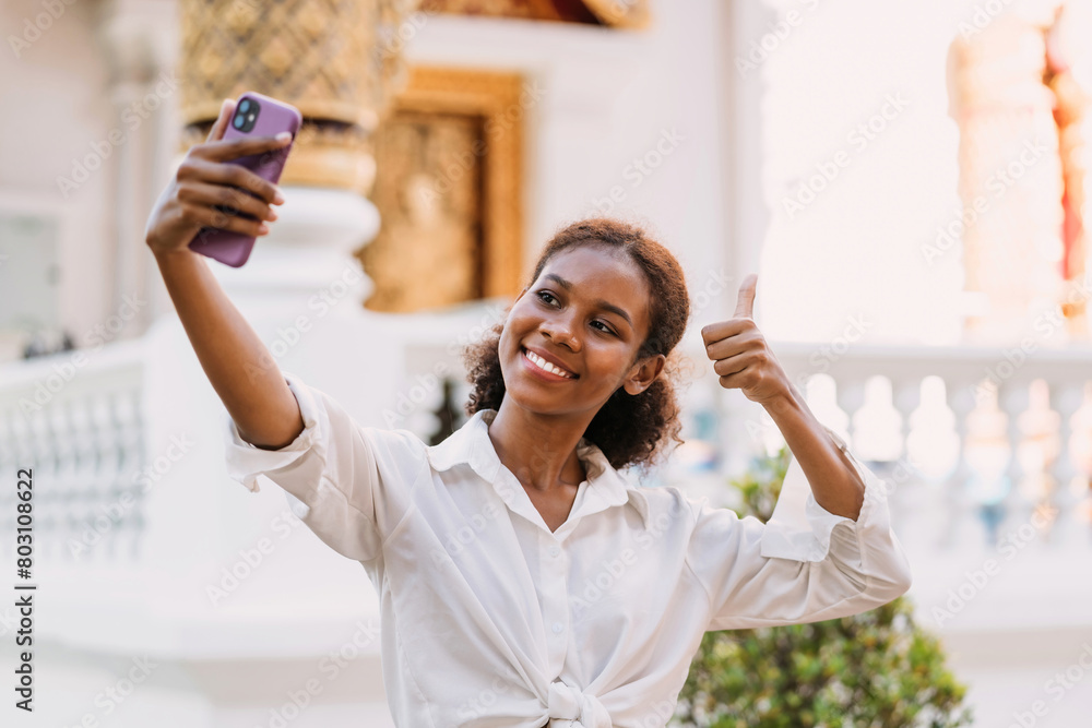 black girl selfie thumb up temple area smiling on vacation. female ...