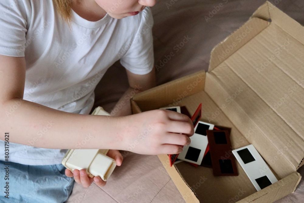 A child is watching slides through a slide show. Retro, slides. Old ...