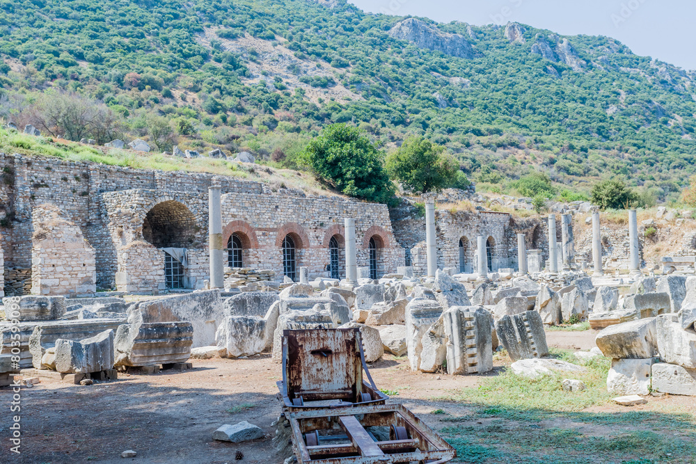 Rusty cart with ancient arches and ruins in the background, in Ephesus ...