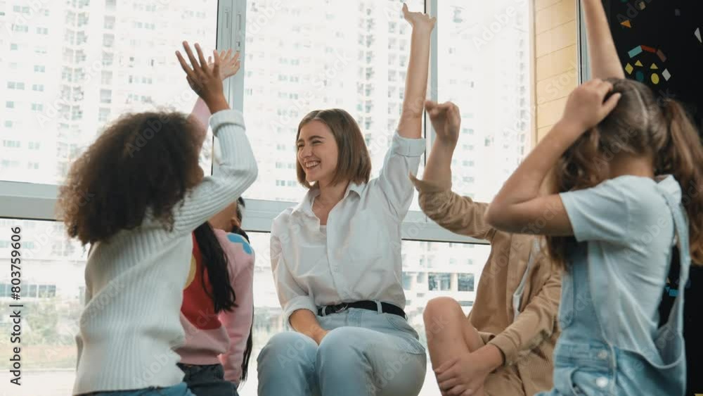 Vidéo Stock Teacher and diverse students putting hands together at ...