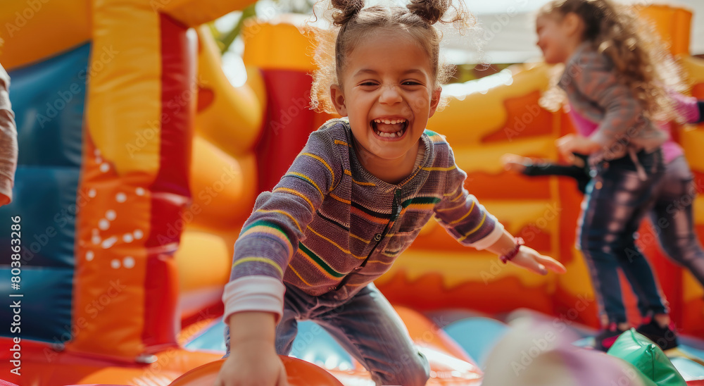 Two children having fun on an inflatable bouncy castle at the school ...