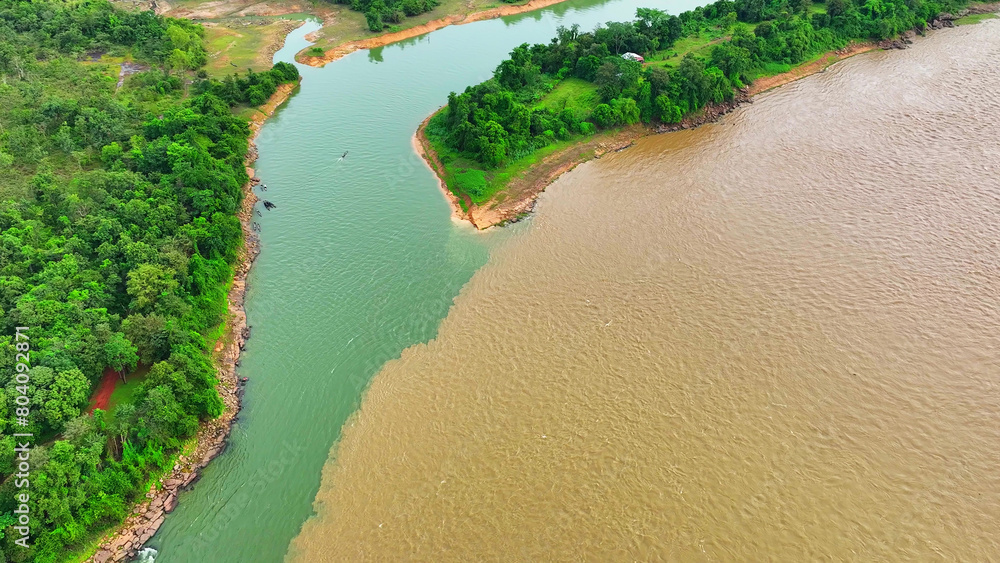 From above, a stunning natural tableau unfolds: Two rivers meet, one a ...