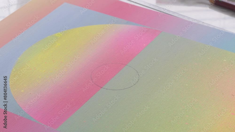 A diverse biracial female artist, uses a circle ruler and a pencil to ...