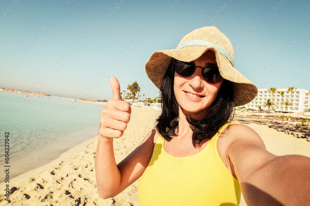 Happy woman tourist smile show thumbs up pose for selfie at beach on ...
