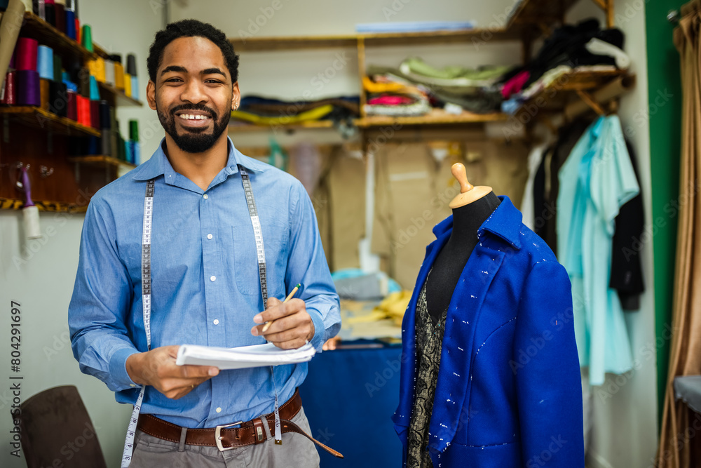 African American men fashion designer, tailor drawing a sketch for his ...