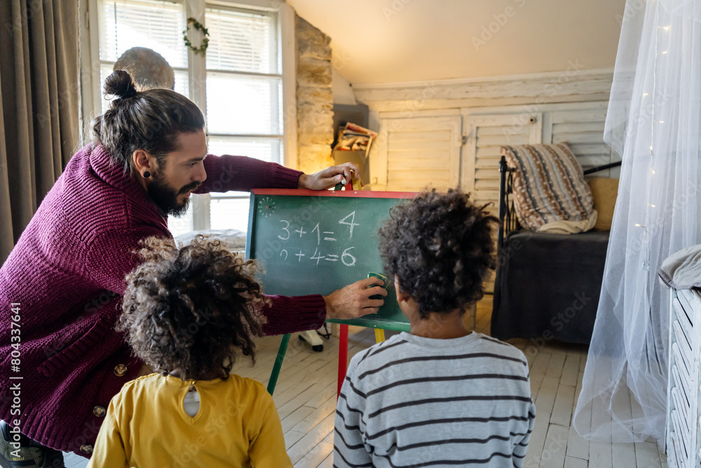 Happy children learning maths with father, teacher at home. Family ...