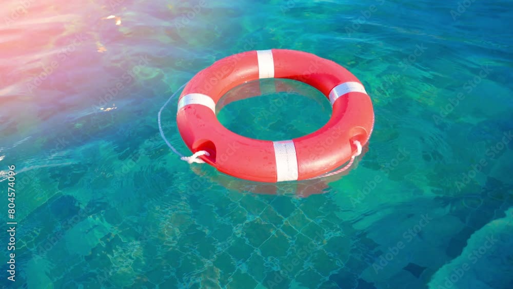 Lifebuoy Floating. Red life buoy over clear blue sea or ocean water ...