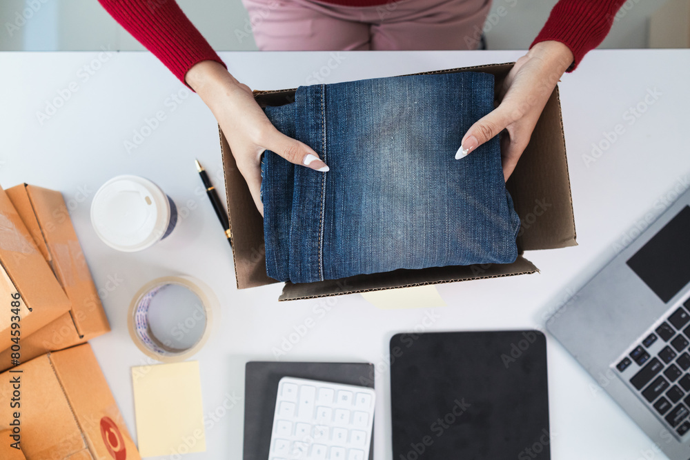 SME business operator is inspecting and packing products into parcel ...