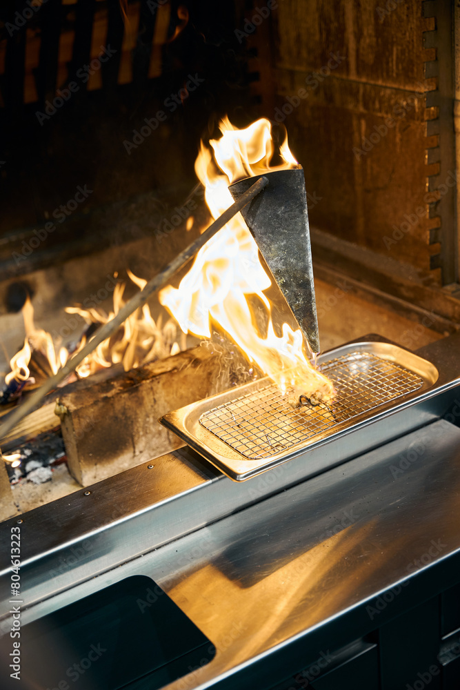 Flambe technique cooking of burning iron triangle pot frying oyster in ...