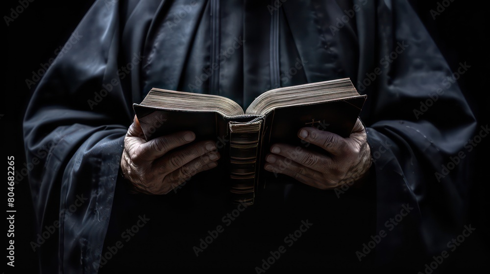 Catholic christian church priest wearing black cassock robe holding the ...