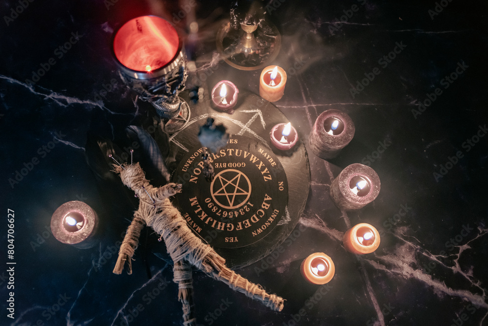 A chilling scene of an occult ritual featuring a voodoo doll pinned ...