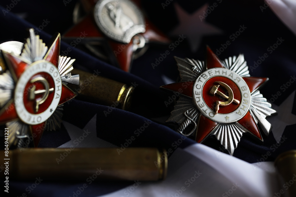 Many bullets cartridges and medals on United States flag. Concept of ...