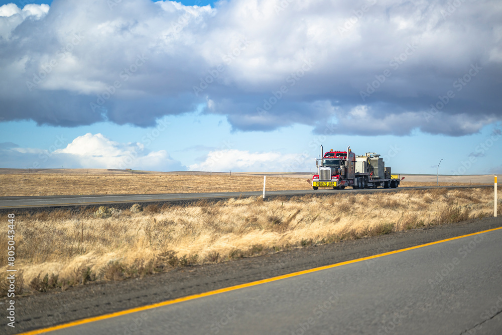 Red classic big rig semi truck with extended cab and oversize load sign ...