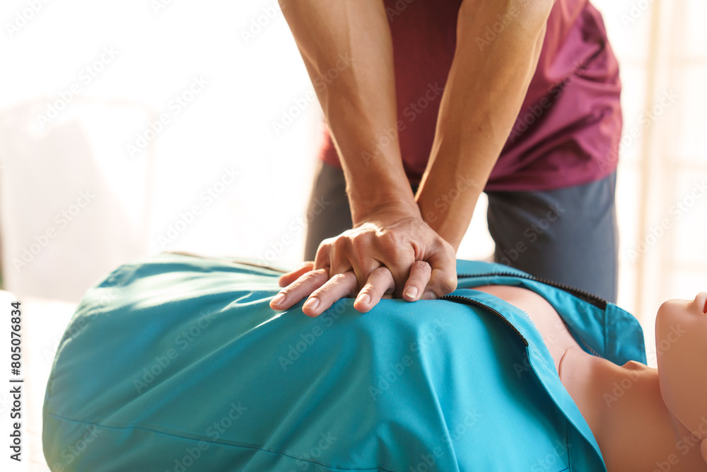 Close-up of middle-aged Asian male hands performing cardiopulmonary ...