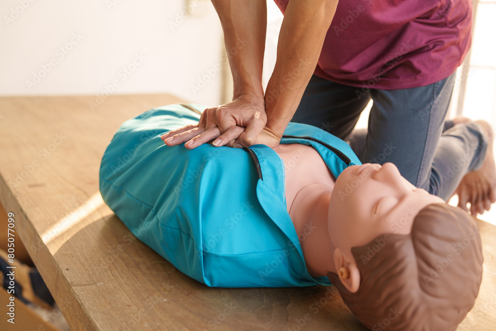 Close-up of middle-aged Asian male hands performing cardiopulmonary ...