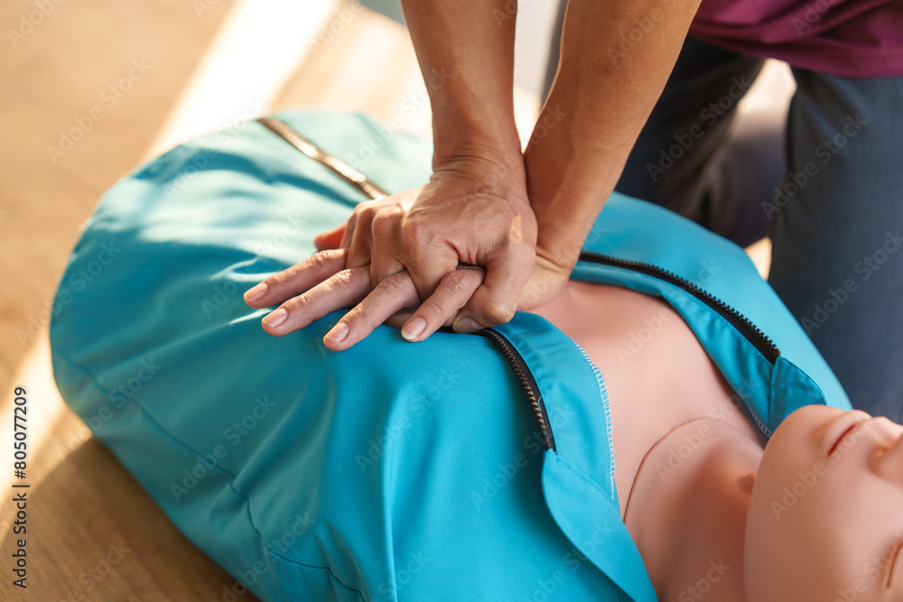 Close-up of middle-aged Asian male hands performing cardiopulmonary ...