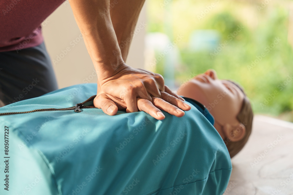 Close-up of middle-aged Asian male hands performing cardiopulmonary ...