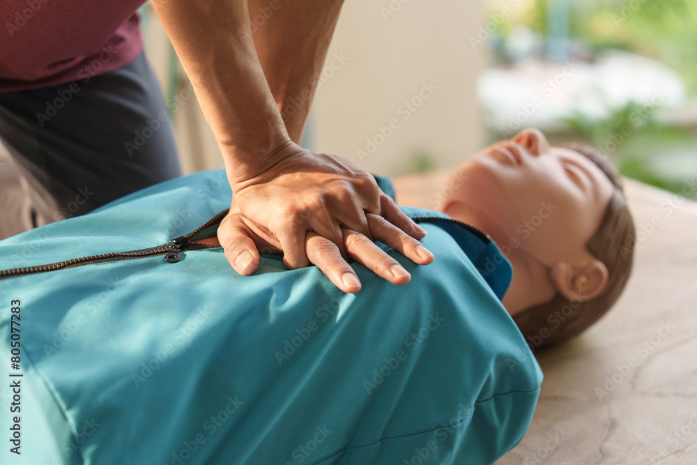 Close-up of middle-aged Asian male hands performing cardiopulmonary ...
