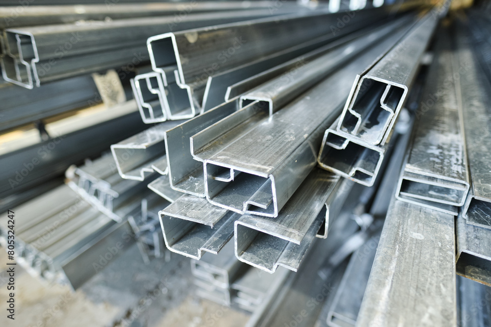 Metal steel square piping pipes stacked up on an industrial heavy duty ...