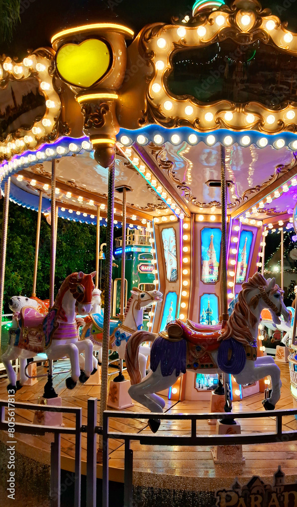 Carousel in an amusement park. Horses on a traditional vintage carousel ...