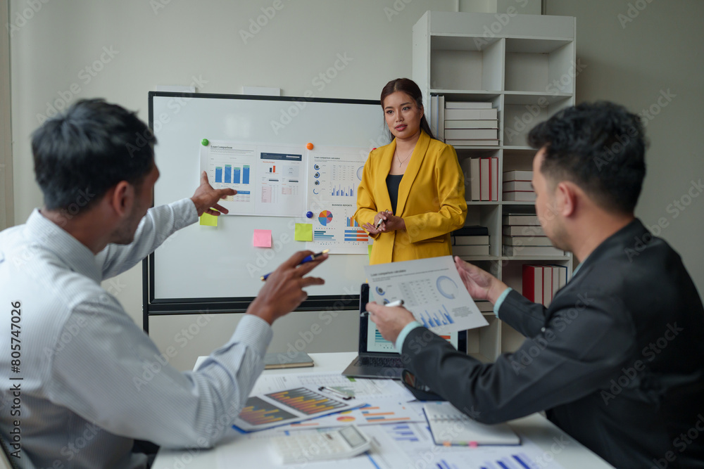 Foto de An operations manager presents a meeting to a team of ...