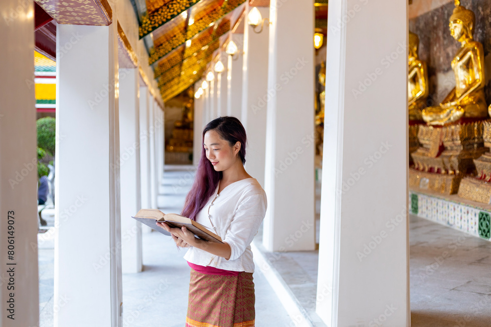 Asian buddhist woman is reading Sanskrit ancient Tripitaka book of Lord ...