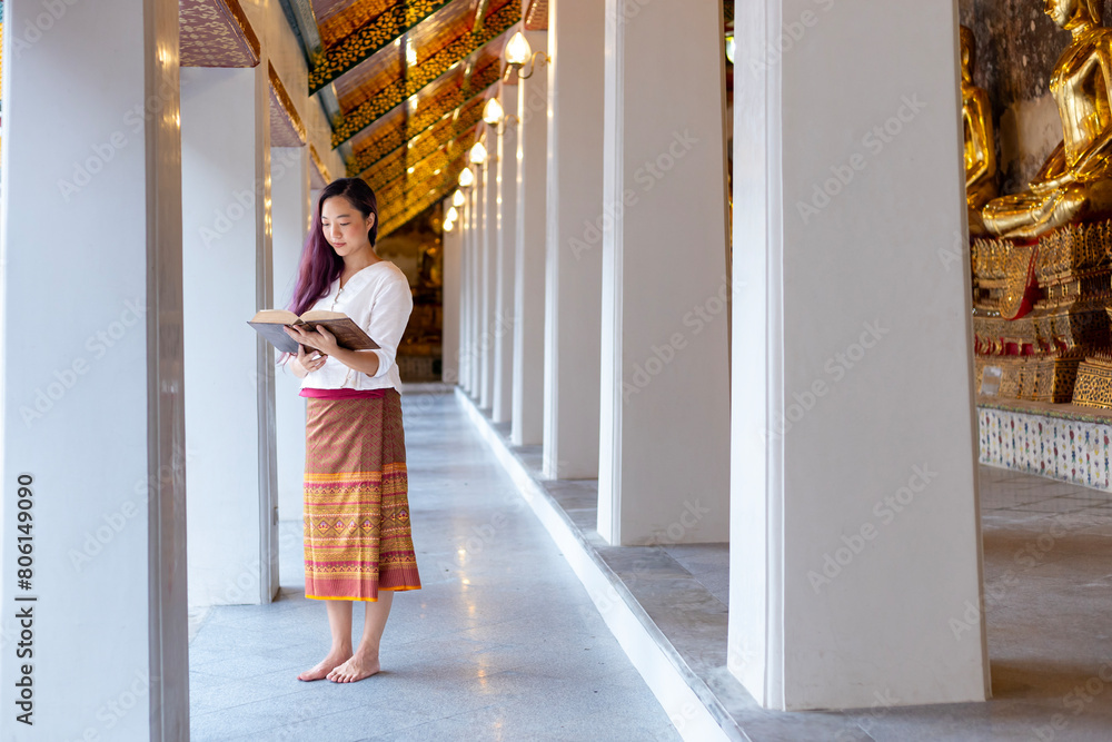 Asian buddhist woman is reading Sanskrit ancient Tripitaka book of Lord ...