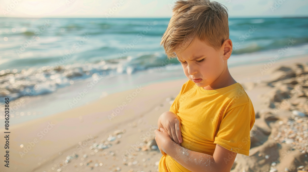 upset boy holding his sore stomach on the beach, diarrhea, poisoning ...