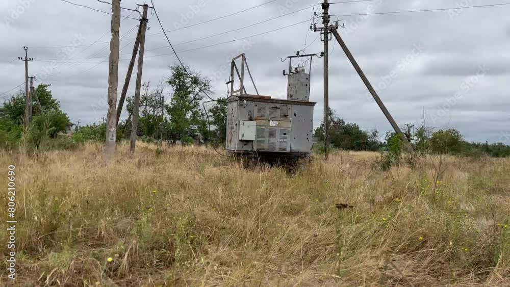 Destroyed transformer box with insulators next to concrete pillars ...