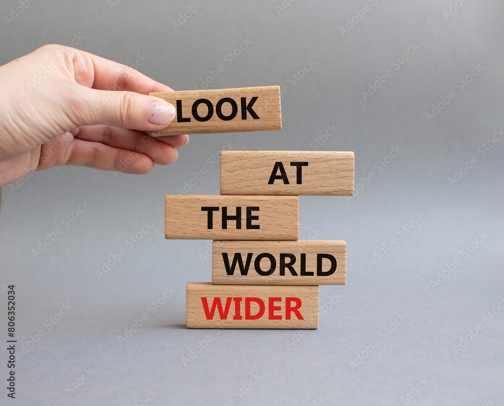 Look at the world wider symbol. Wooden blocks with words Look at the ...