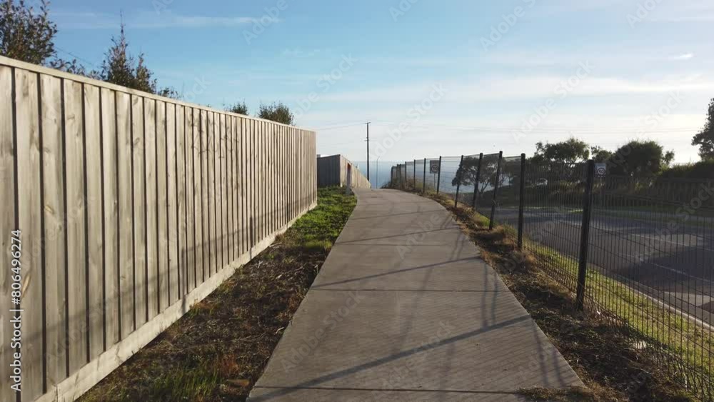 A pedestrian walkway with a guardrail fence to barricade foot traffic ...
