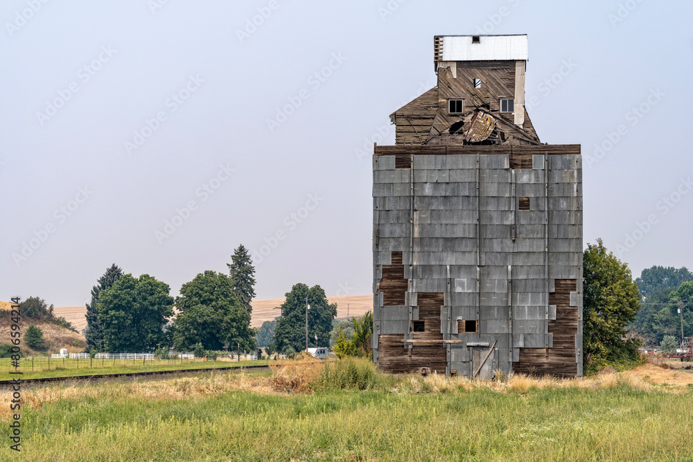 Sections of metal siding have fallen off an abandoned grain elevator in ...
