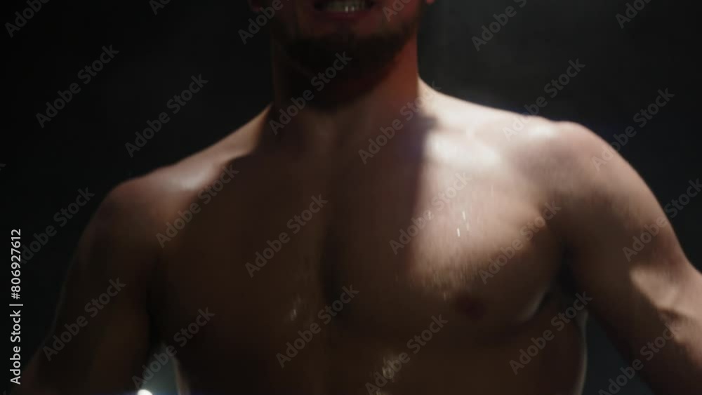 aggressive mma fighter flexing his muscles and yelling at the camera ...