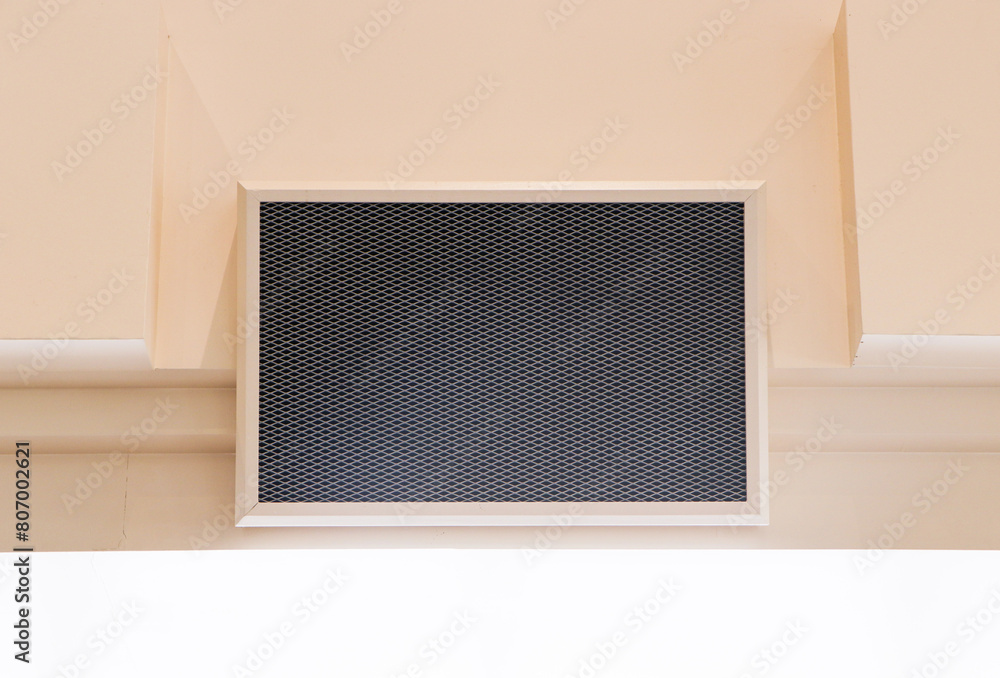 Ventilation air vents are attached to cream color beams of structure ...
