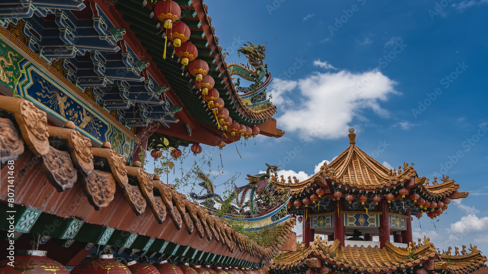 Details of the architecture of a beautiful Chinese temple. The tiled ...