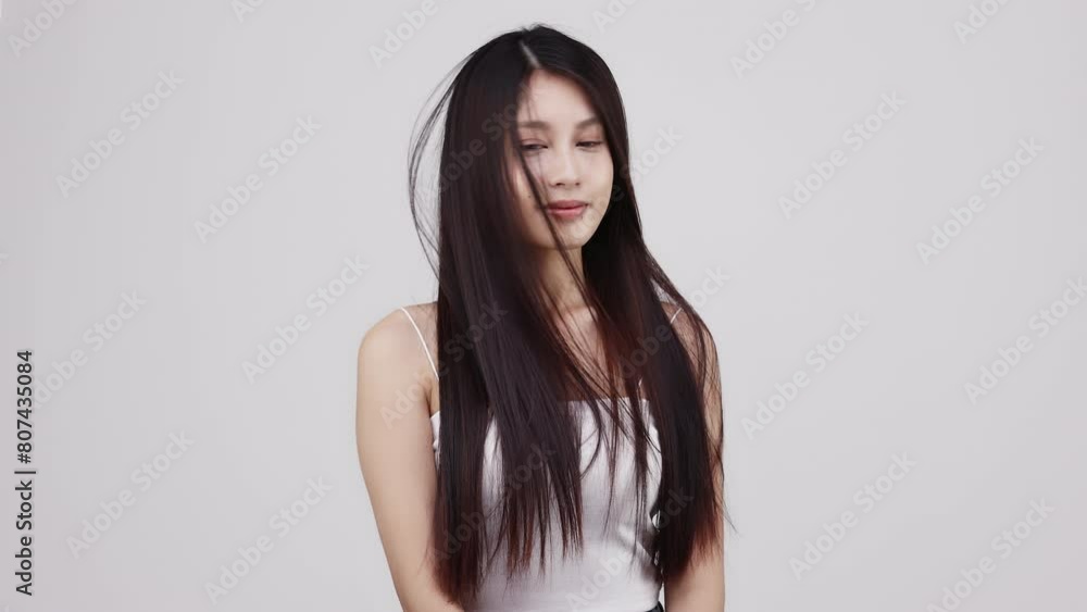 Slow motion shot young Asian woman shaking hair and beauty with shine ...