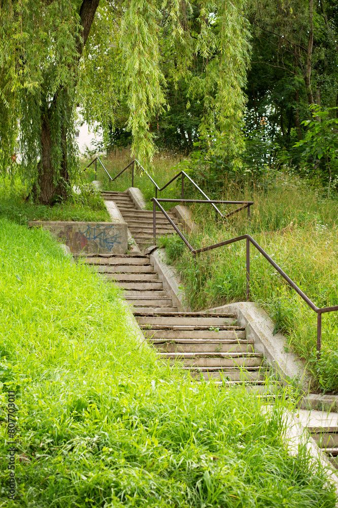 Geometric stair design with green grass around it. Concrete stairs with ...
