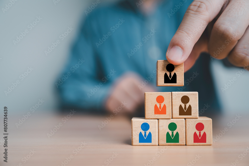 Businessman stacking human icon which print screen on wooden block cube ...