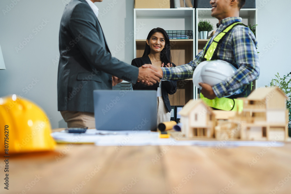 Team architects workers, men and women, join hands to join forces to ...