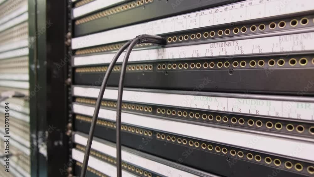 Patch panel in broadcast center, black SDI cable connected into BNC ...