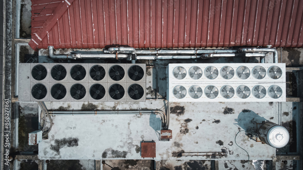 Air conditioner compressor on a building's rooftop, accompanied by ...