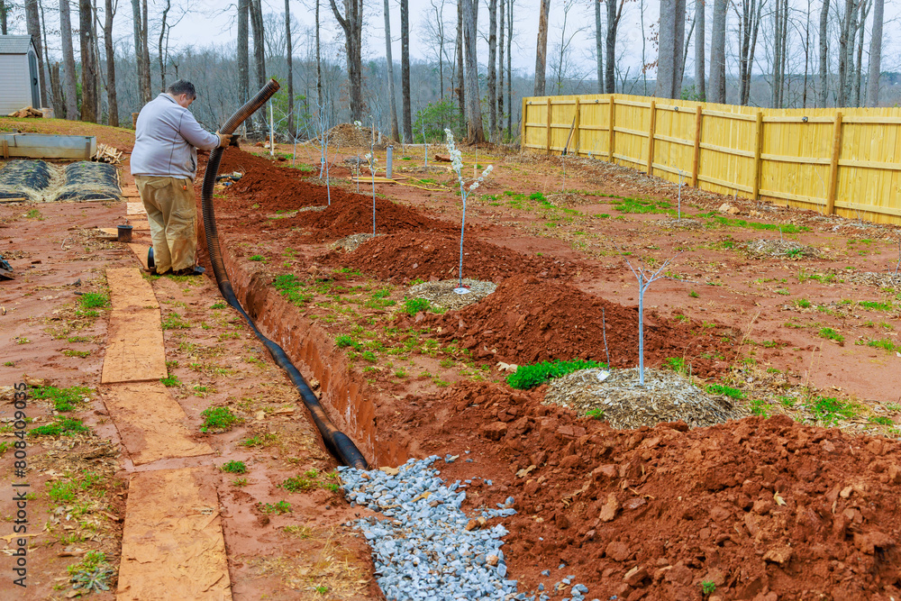 An installation of storm drainage drain pipe into trench drain for ...