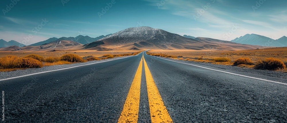 A symmetrical asphalt highway stretches endlessly towards a towering ...