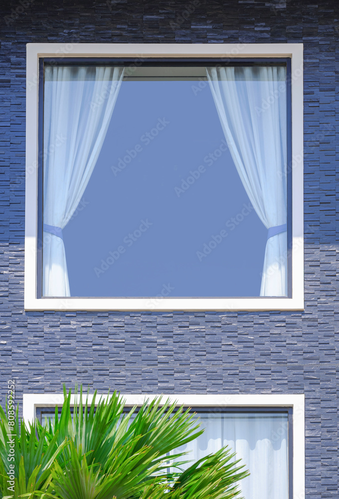 2 large square glass windows with white curtain on gray stone slate ...