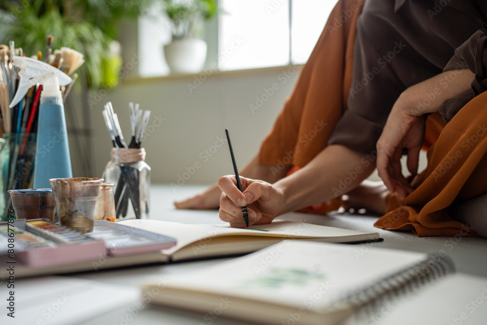 Elegant hand of female painter drawing with brush. Professional woman ...