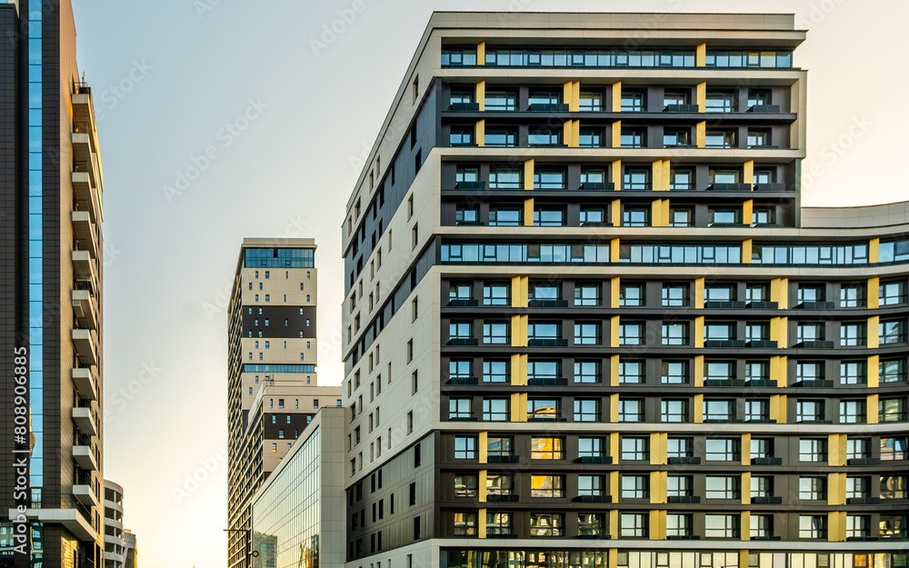 Part of the wall of a high-rise building made of concrete and glass ...